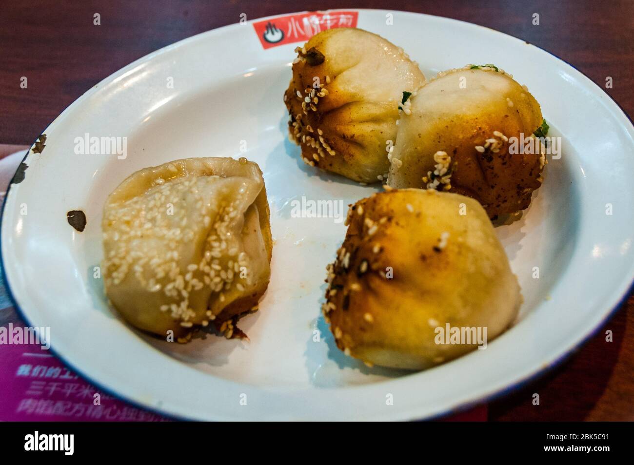 An old style enamel plate of shengjianbao dumplings at Yang’s Fried ...