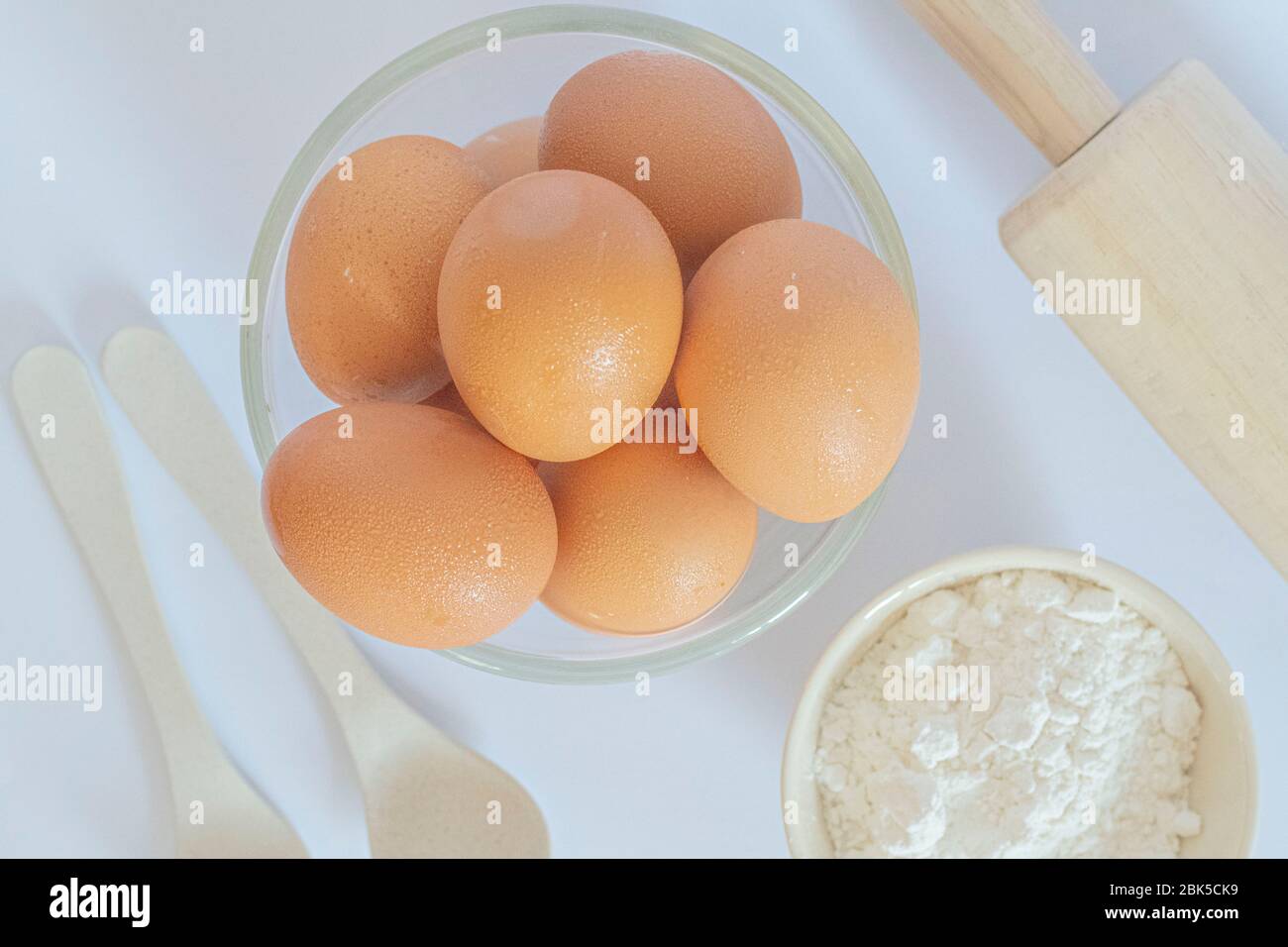 Eggs and corn flour on a white background Stock Photo - Alamy
