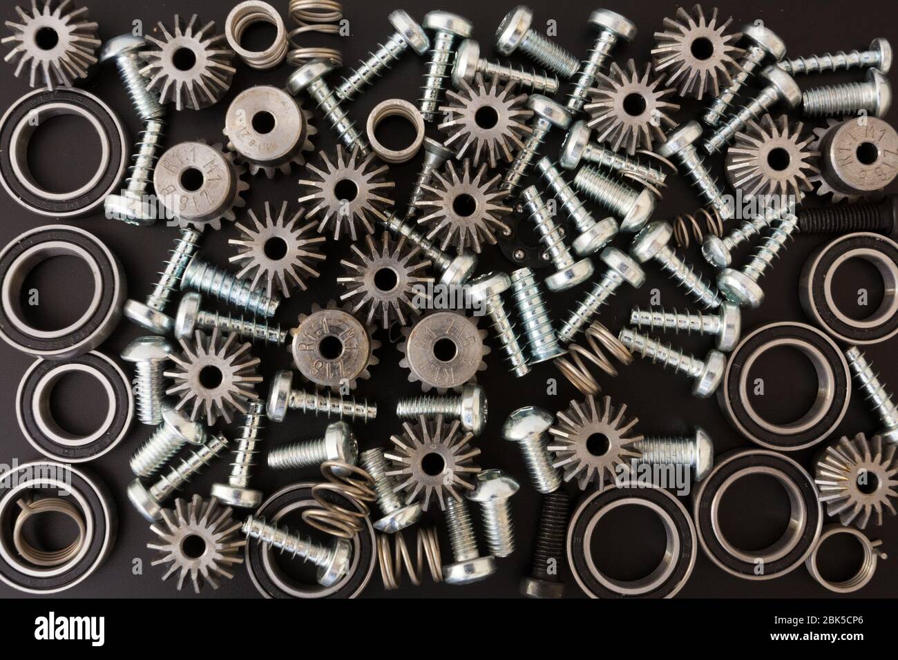 Background with mechanical components, gears, springs, screws ...