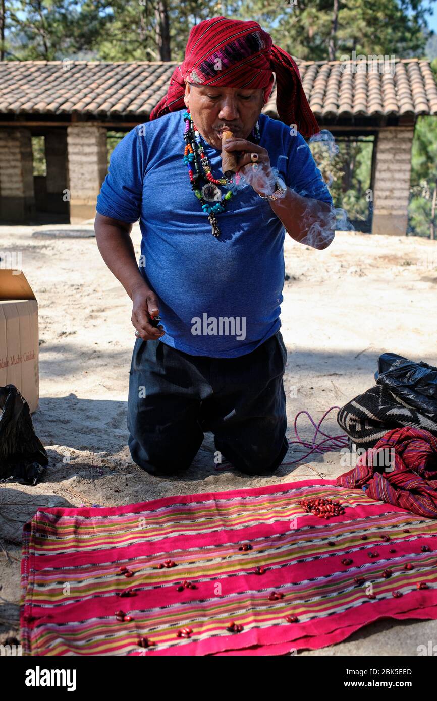 Shaman performing a Mayan healing ceremony for a family on the top of ...