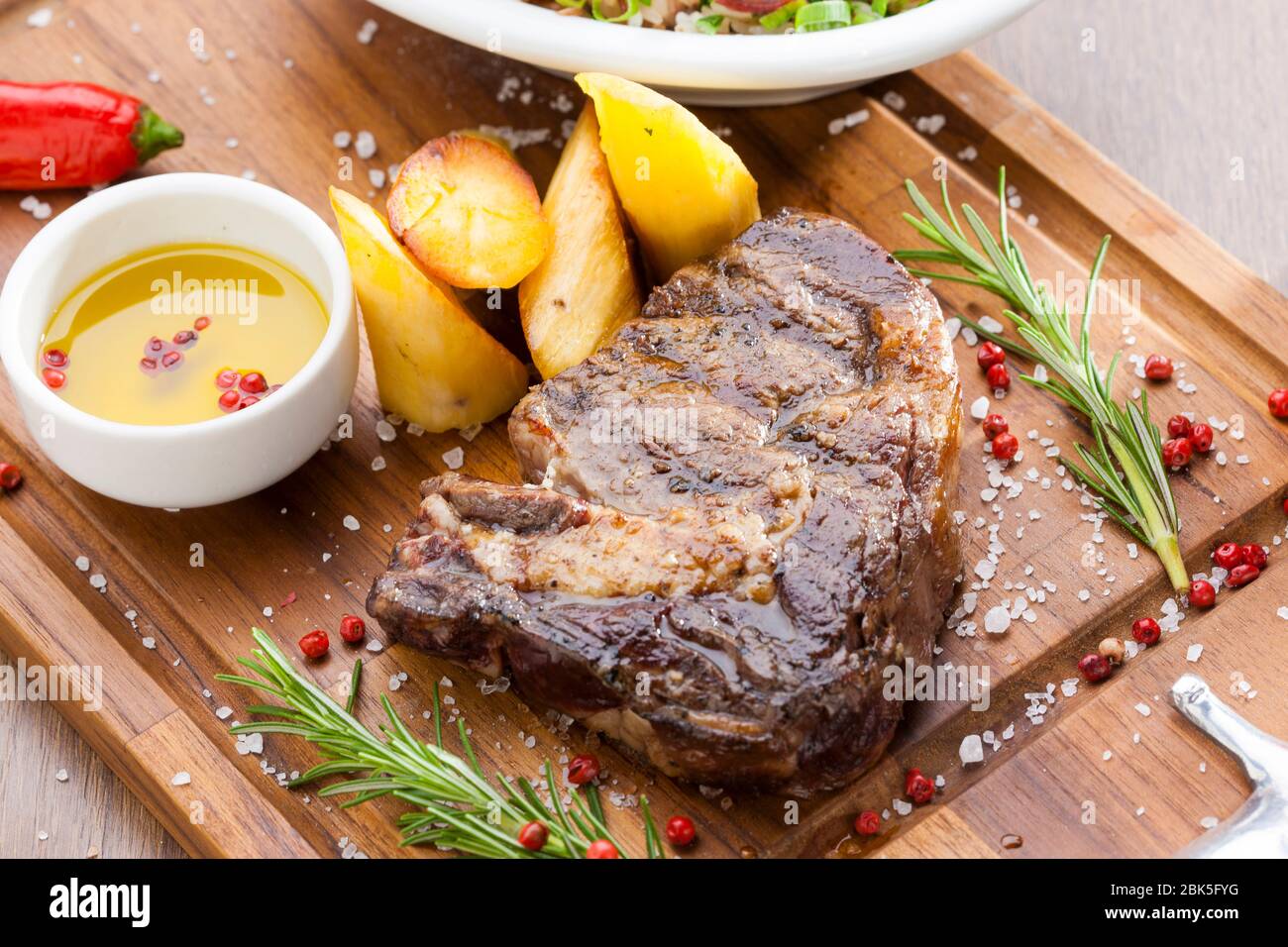 delicious T-bone barbecue steak served with french fries, rice and ...