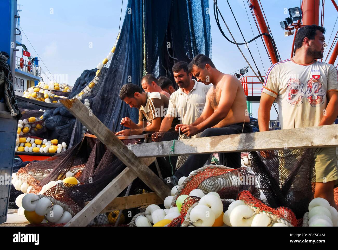 TRABZON / TURKEY - AUGUST 28, 2006: Fishermen repair fishing nets. Of ...