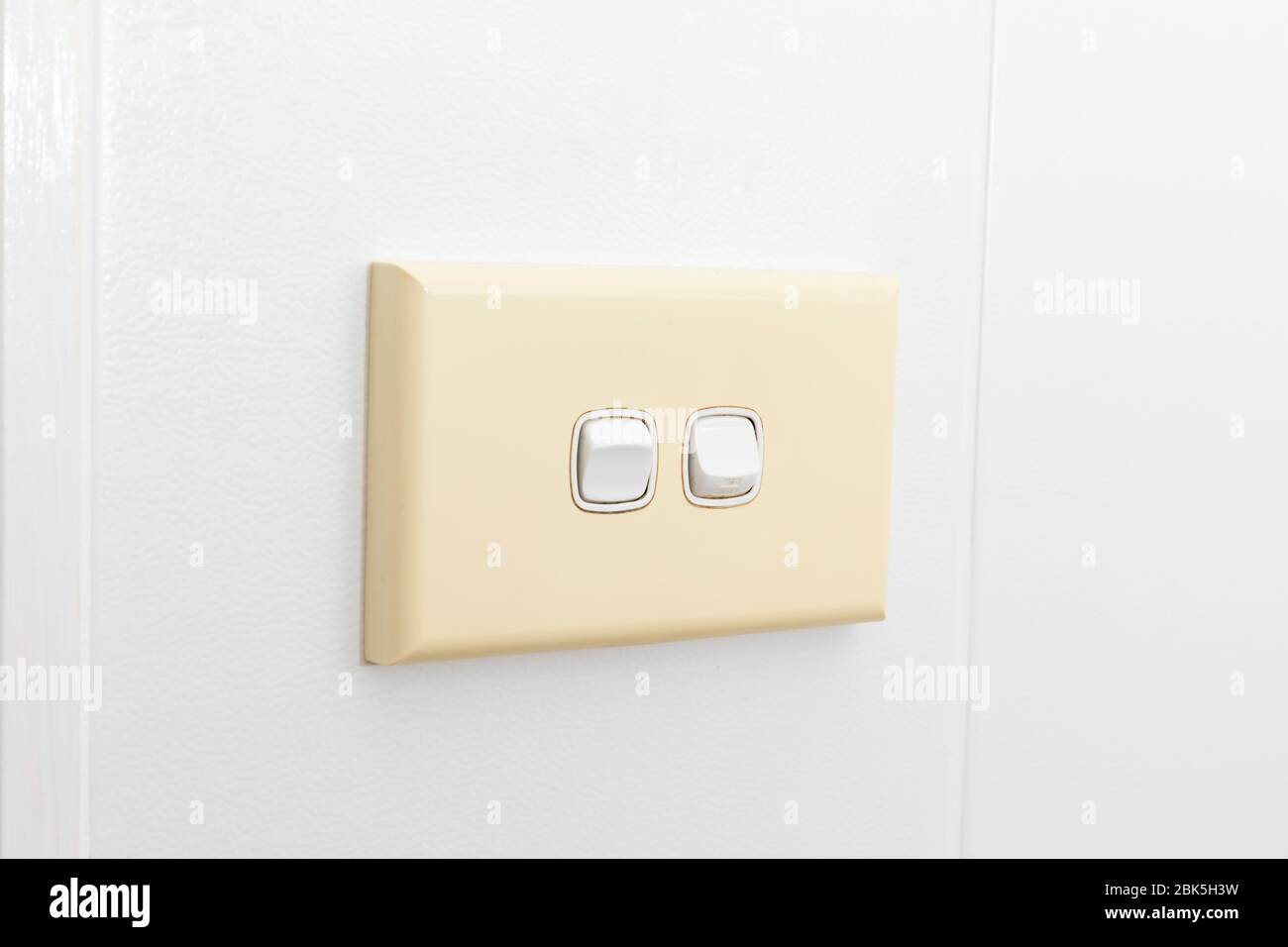 A double light switch on a white tiled wall Stock Photo - Alamy