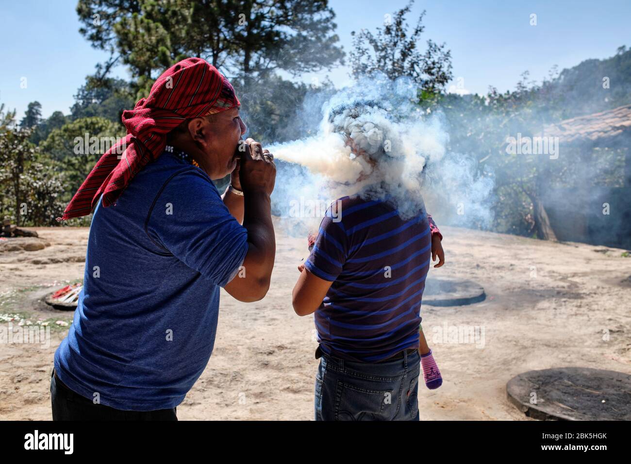 Shaman performing a Mayan healing ceremony for a family on the top of ...