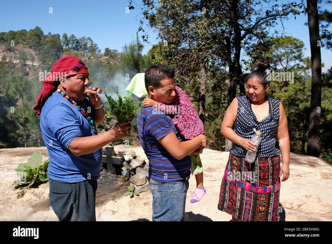 Shaman performing a Mayan healing ceremony for a family on the top of ...