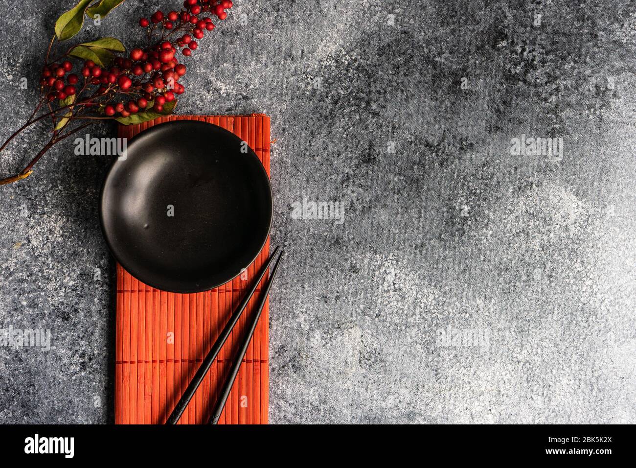 Asian table setting with wooden chopsticks and ceramic bowls on stone ...