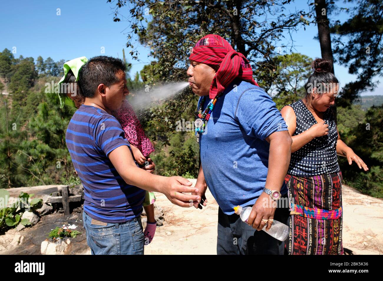 Shaman performing a Mayan healing ceremony for a family on the top of ...