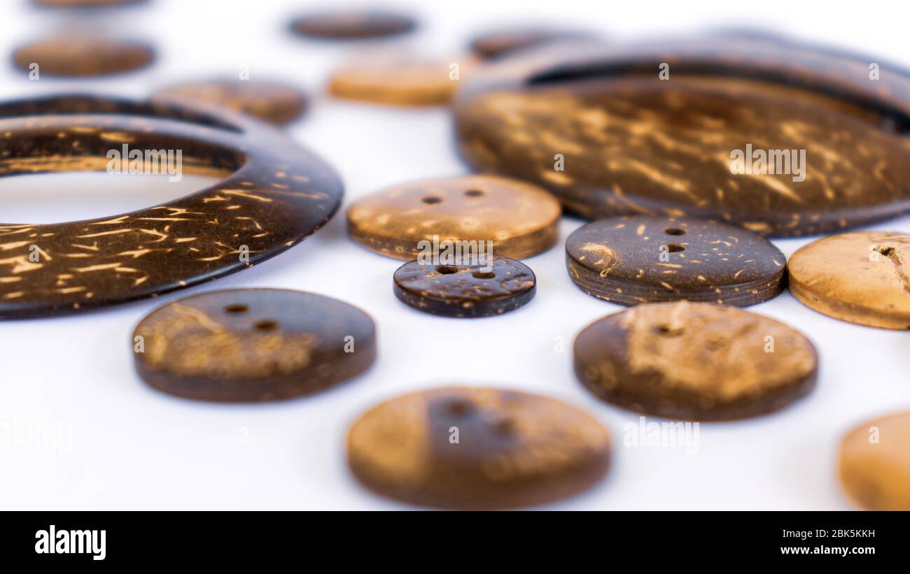 Coconut shell buttons spreads across white background Stock Photo - Alamy