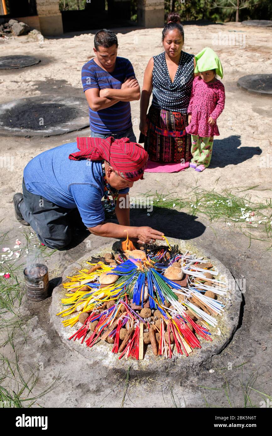 Shaman performing a Mayan healing ceremony for a family on the top of ...