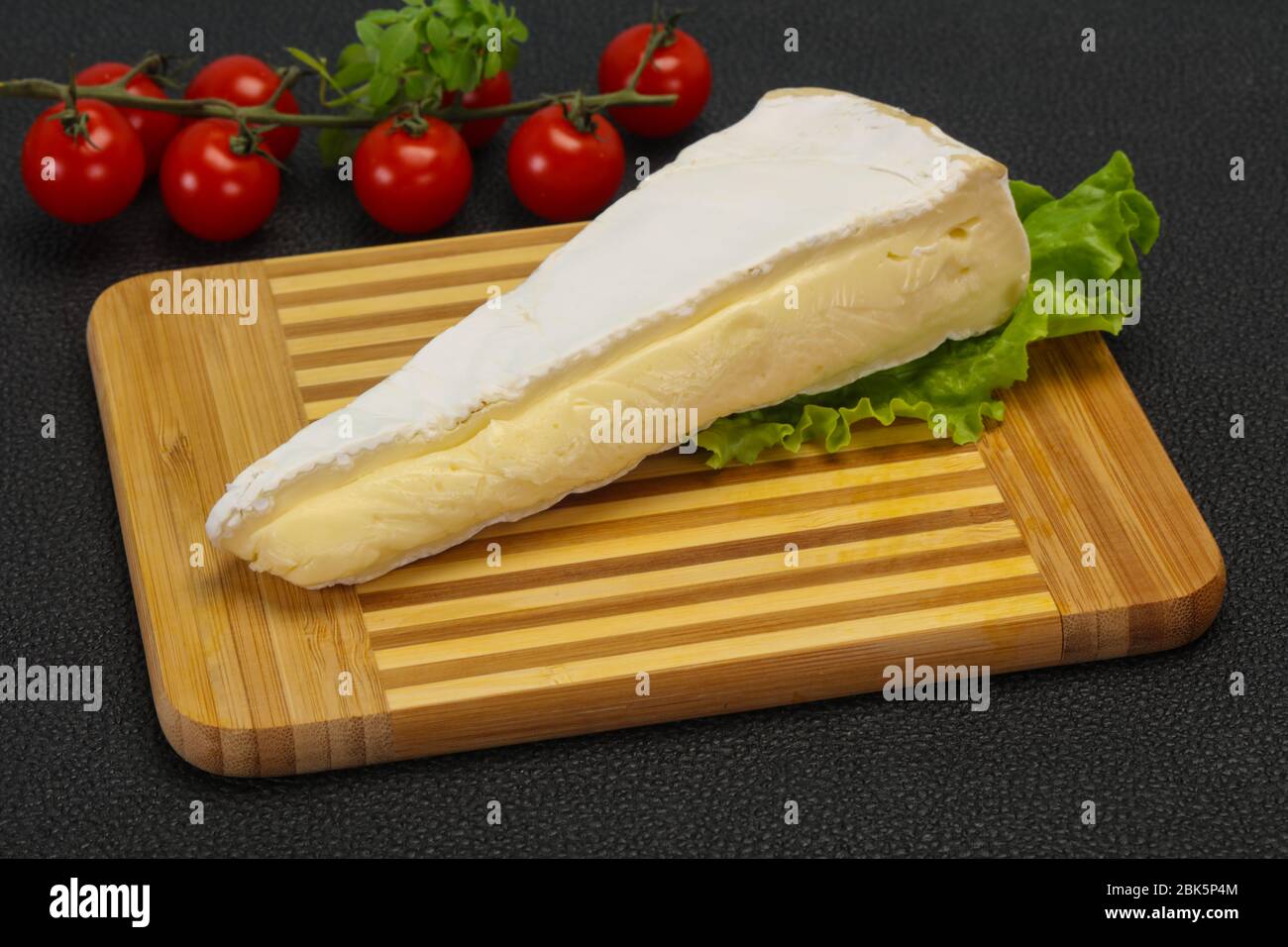 Brie cheese triangle served salad leaves Stock Photo - Alamy