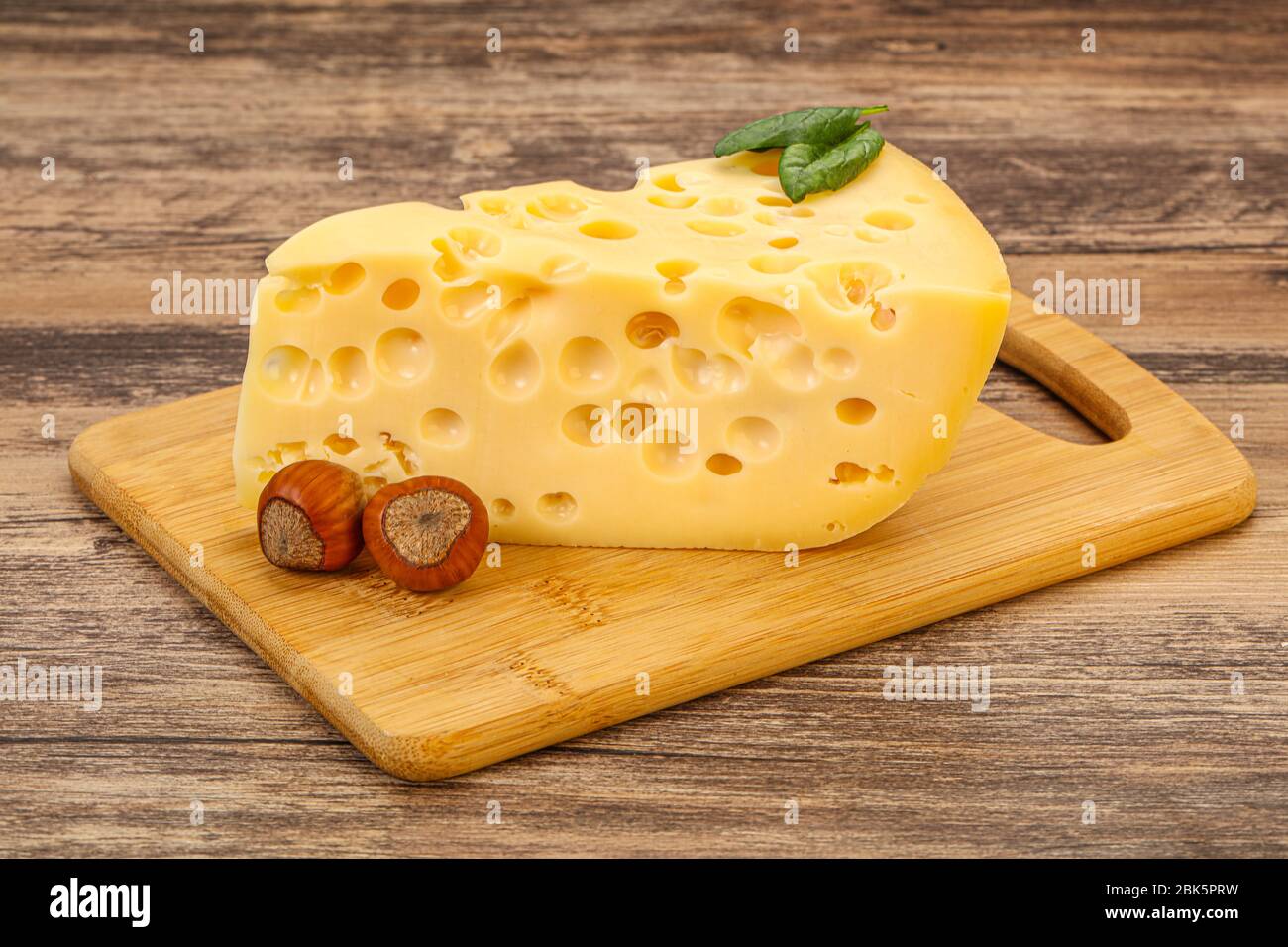 Maasdam cheese - dairy yellow triangle with holes Stock Photo - Alamy
