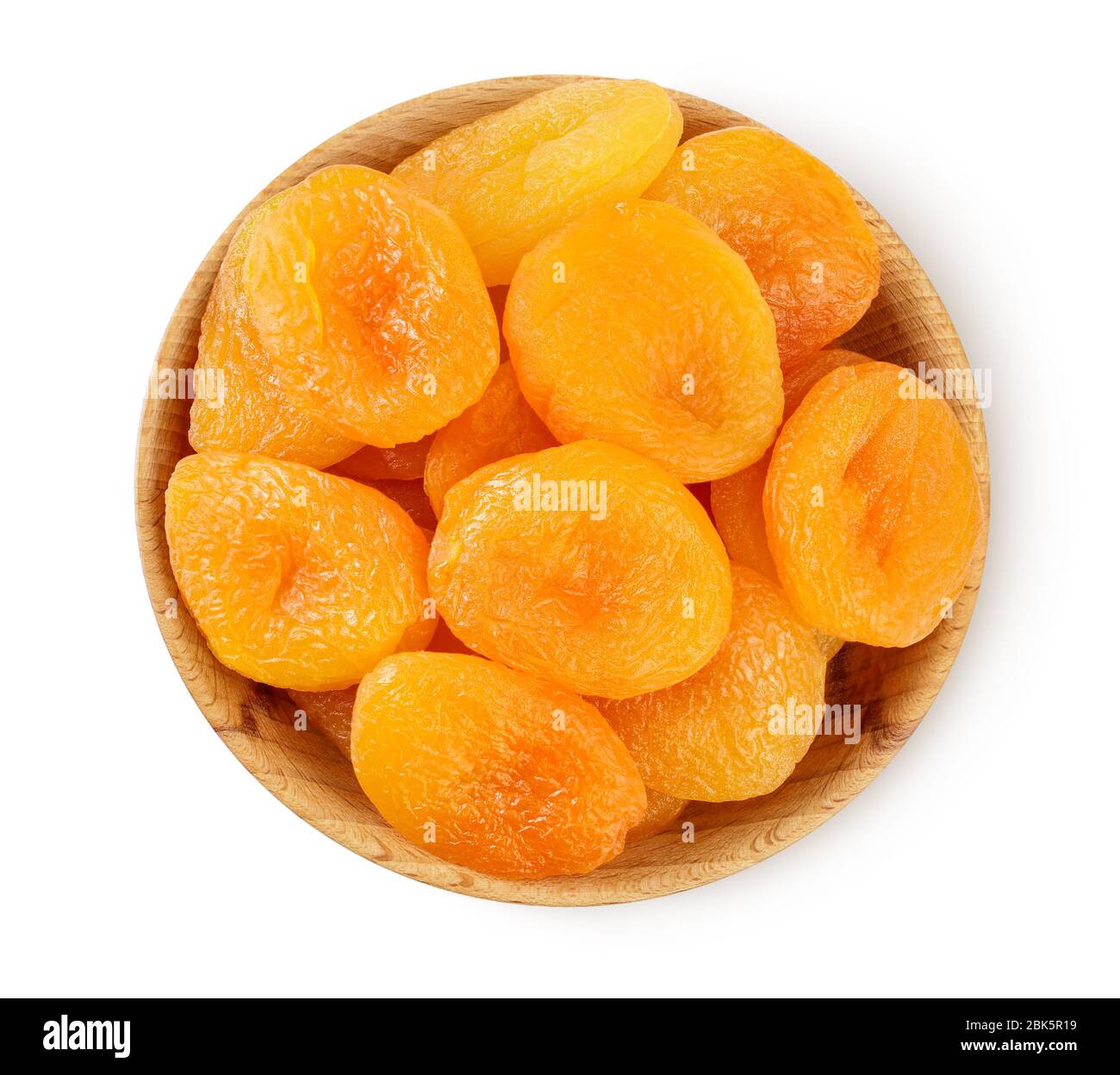Dried apricots in wooden bowl isolated on white background with ...