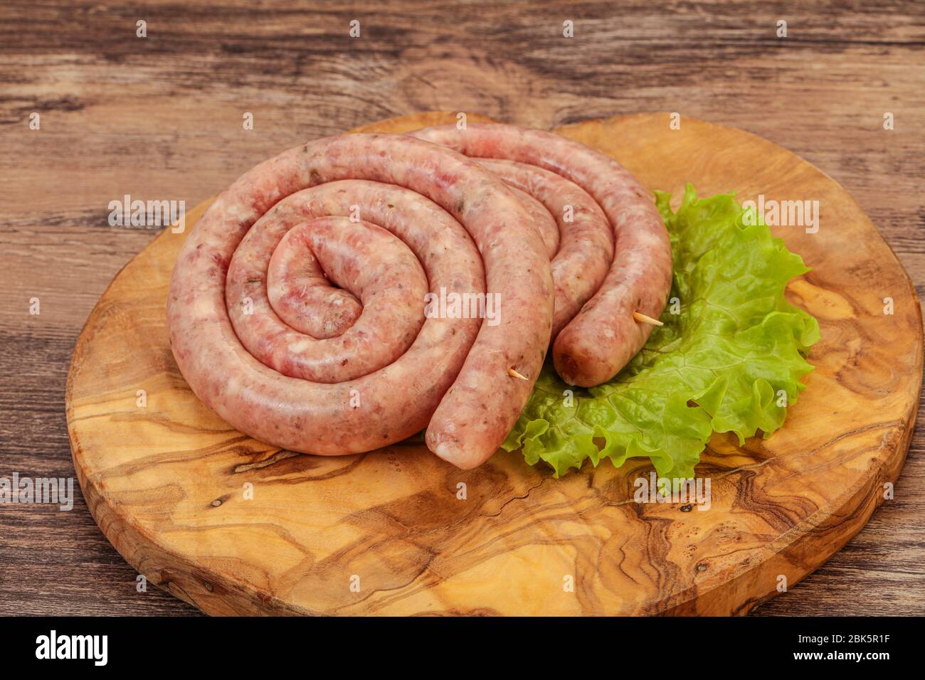 Raw pork sausage ring for grill Stock Photo - Alamy