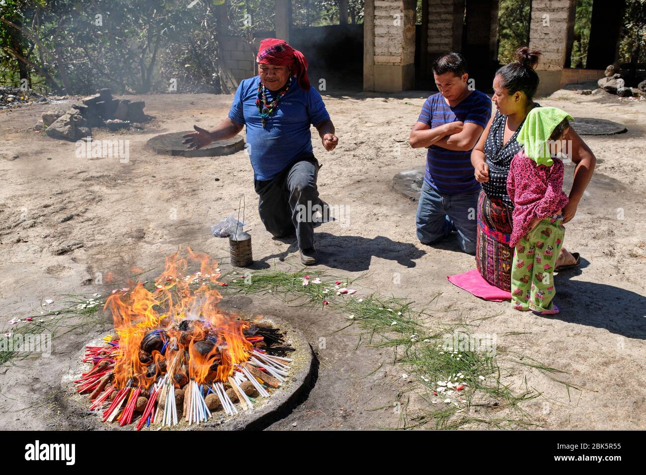 Shaman performing a Mayan healing ceremony for a family on the top of ...