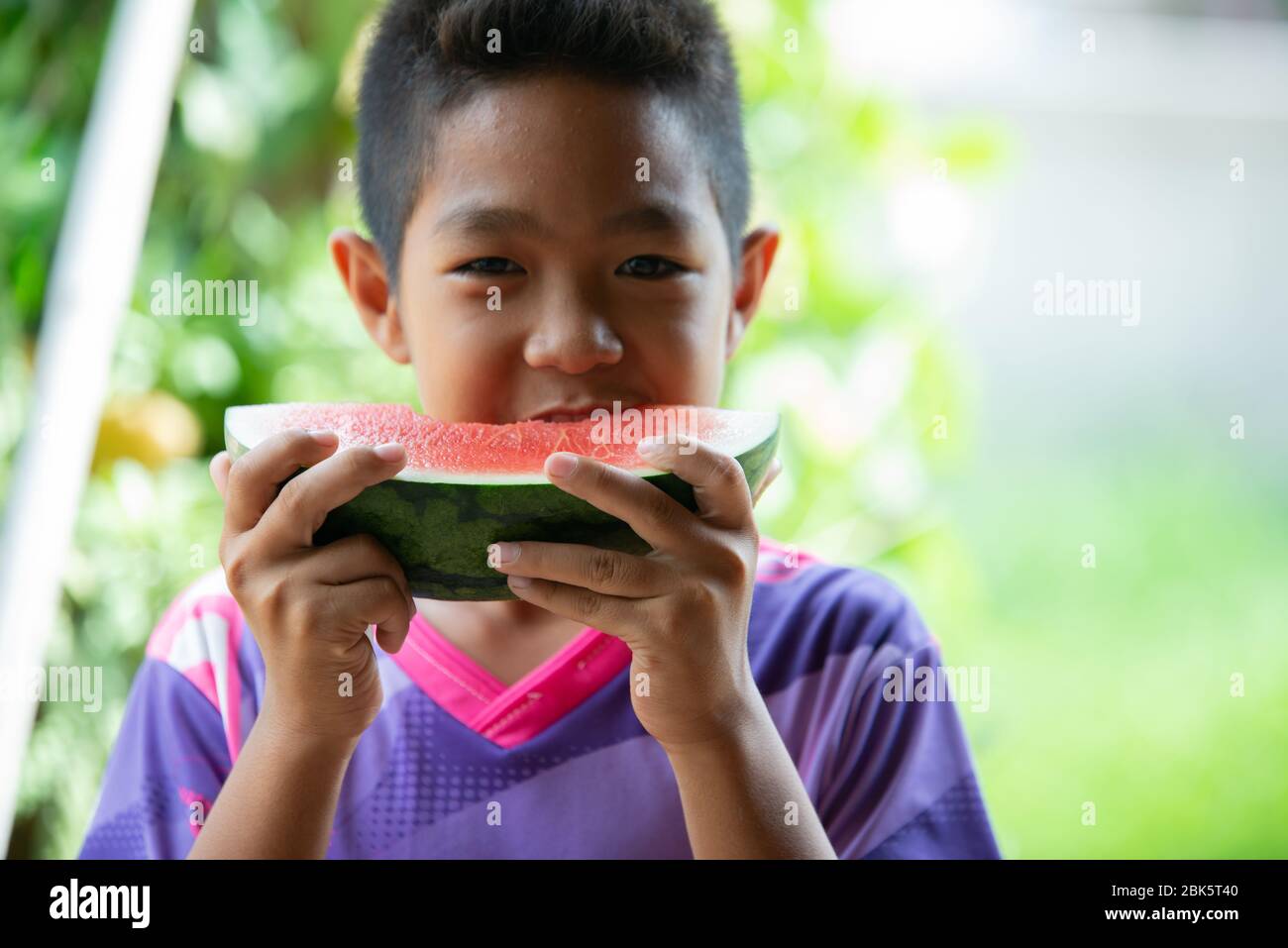 Asian boy eating watermelon, seeds on slice like a smile Stock Photo ...