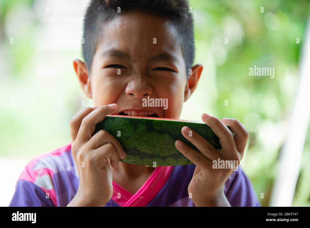Asian boy eating watermelon, seeds on slice like a smile Stock Photo ...