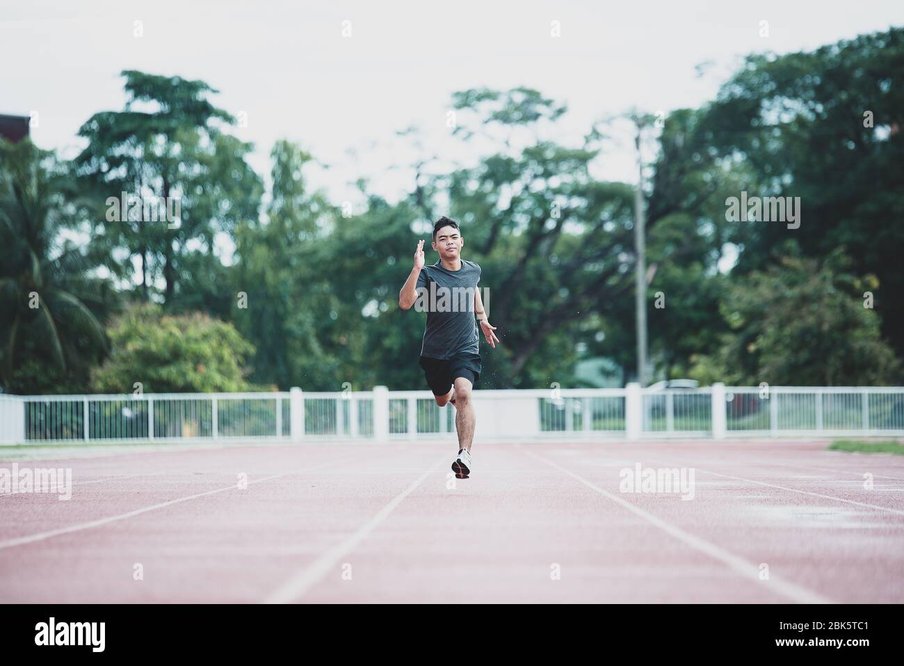athlete standing on an all-weather running track Stock Photo - Alamy