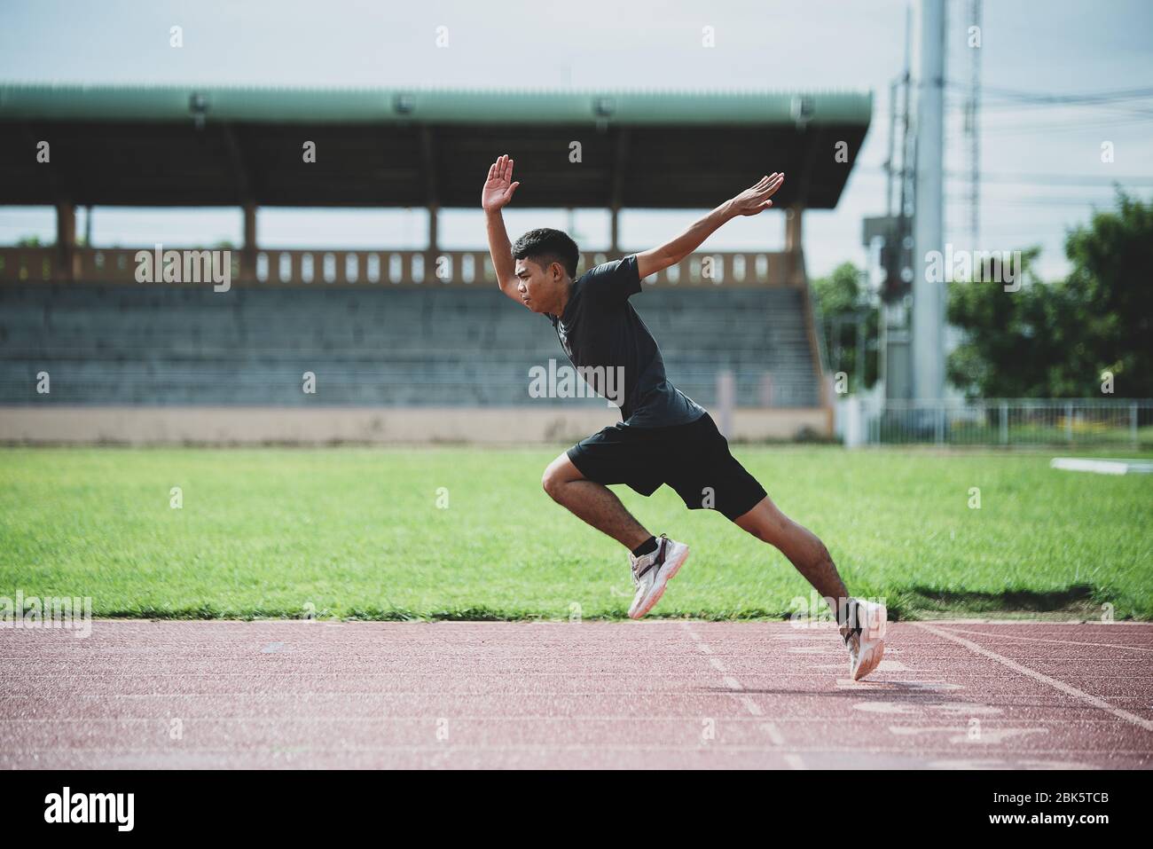 athlete standing on an all-weather running track Stock Photo - Alamy