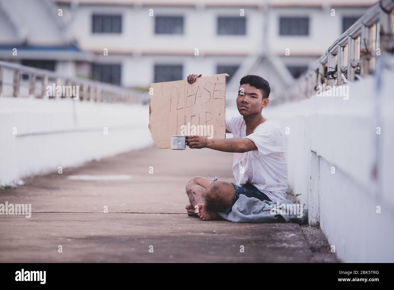 The poor man begs alms, homeless Asian man is begging for money Stock Photo - Alamy