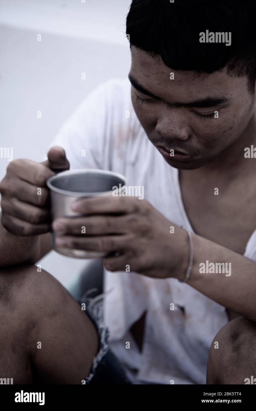 The poor man begs alms, homeless Asian man is begging for money Stock Photo - Alamy