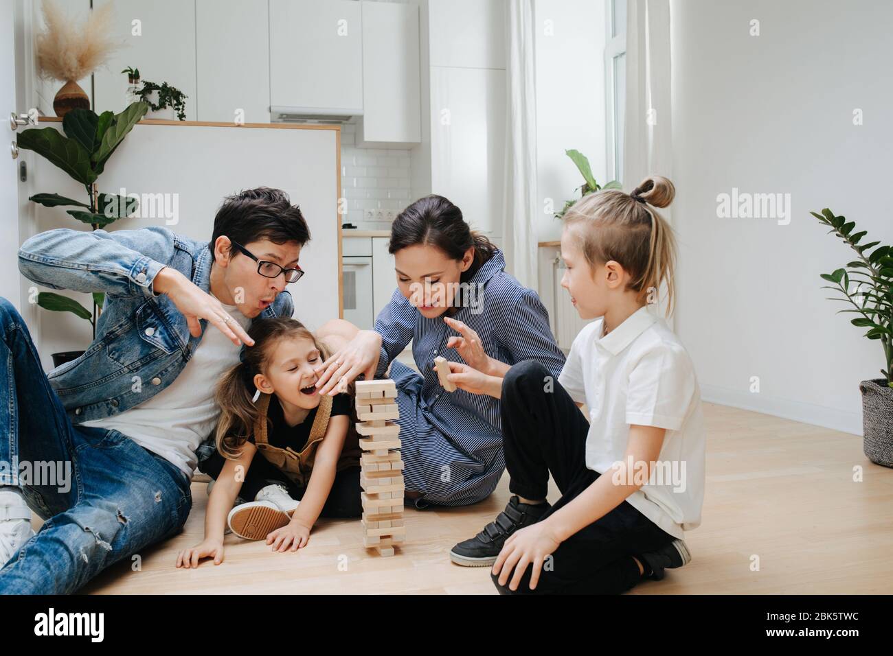 Family playing block tower hi-res stock photography and images - Alamy