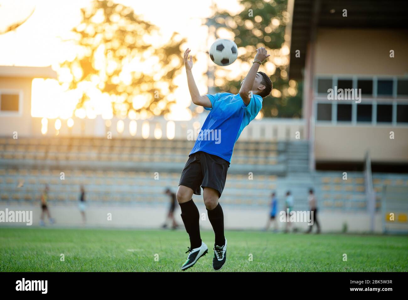 Soccer player action on the stadium Stock Photo - Alamy
