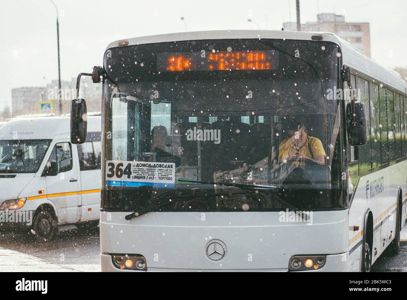 Moscow, Russia - MAY 2, 2018: A city bus driver sits and uses the phone ...
