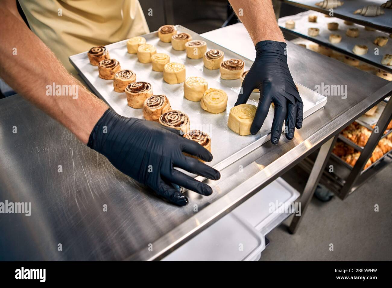 Professional chef making mini cinnamon rolls on kitchen Stock Photo - Alamy