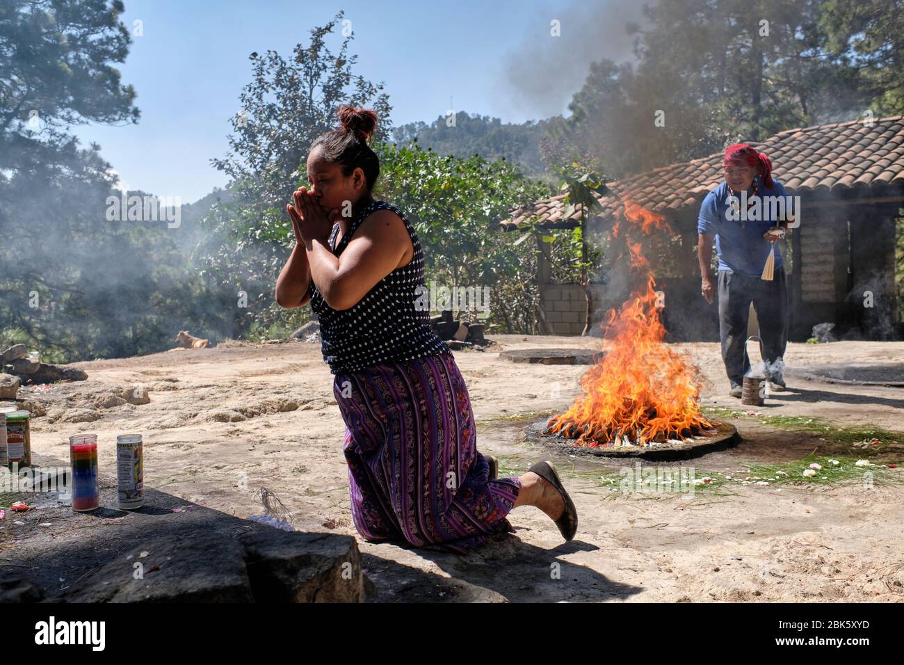 Shaman performing a Mayan healing ceremony for a family on the top of ...