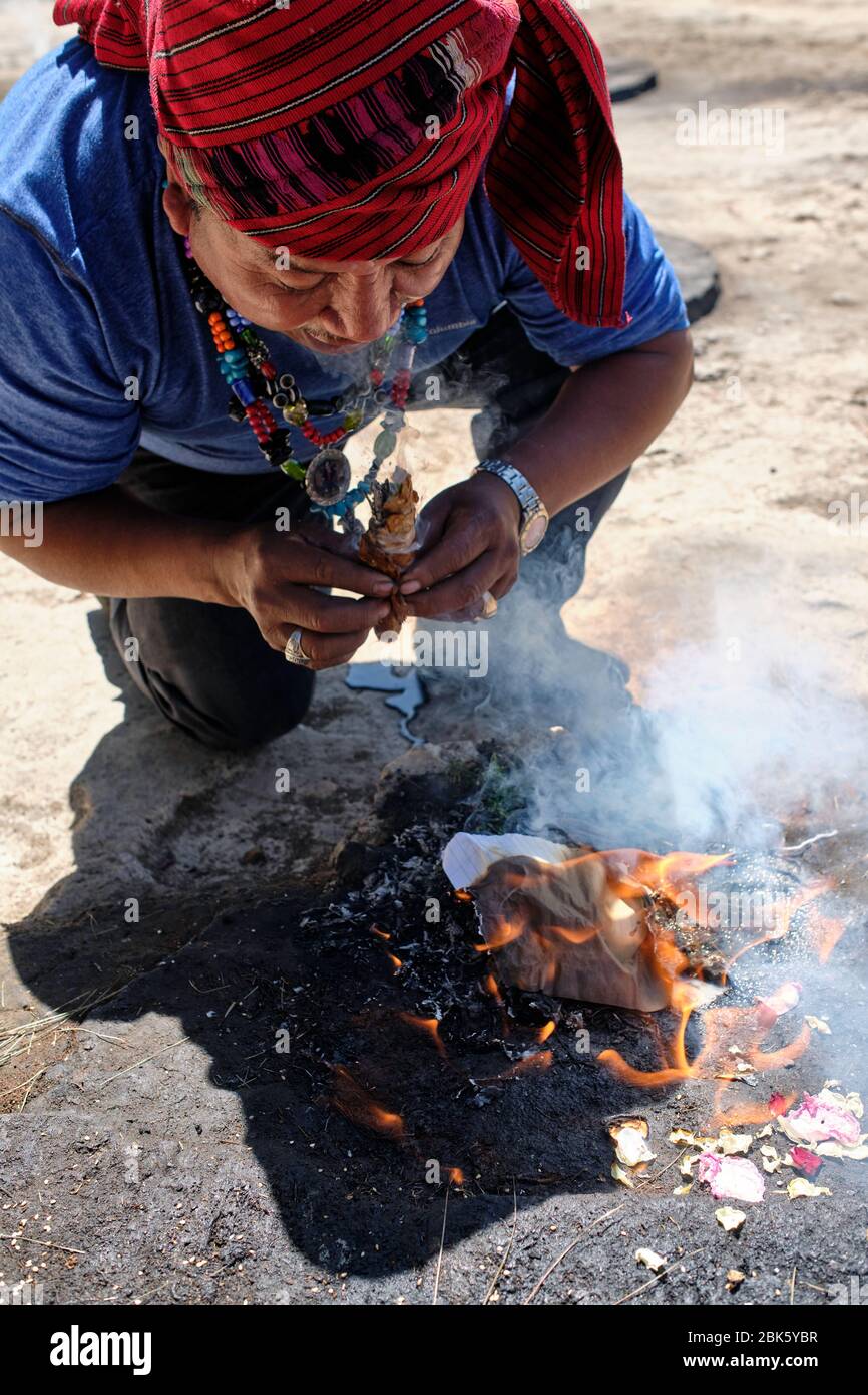 Shaman performing a Mayan healing ceremony for a family on the top of ...