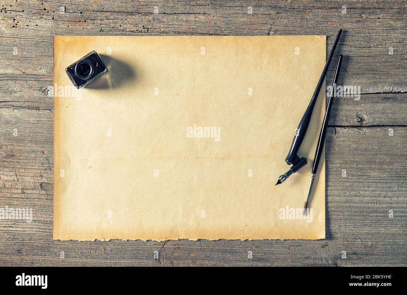 Old paper sheet and writing tools. Ink pen, inkwell. Vintage toned ...