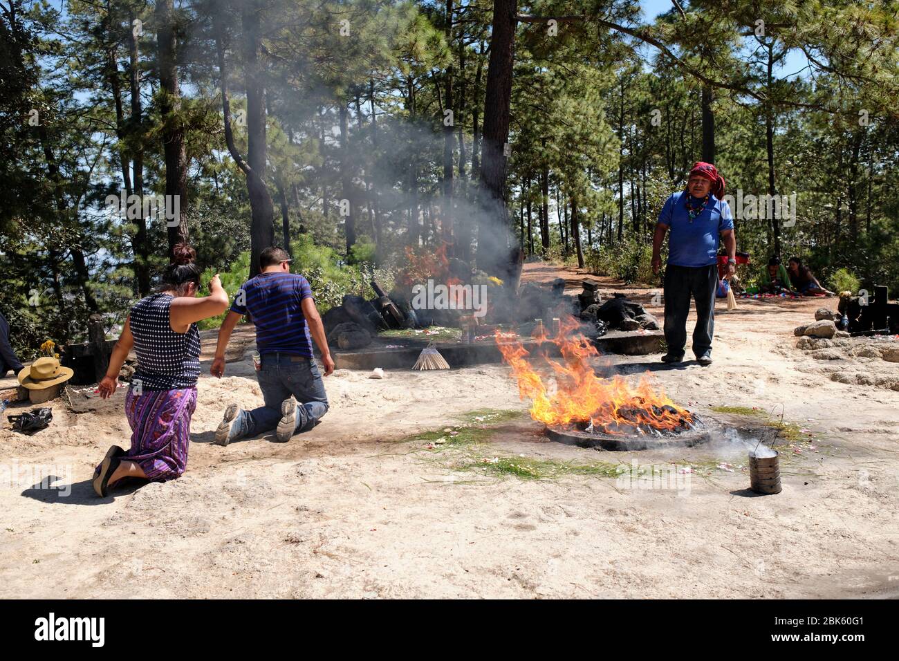 Shaman performing a Mayan healing ceremony for a family on the top of ...