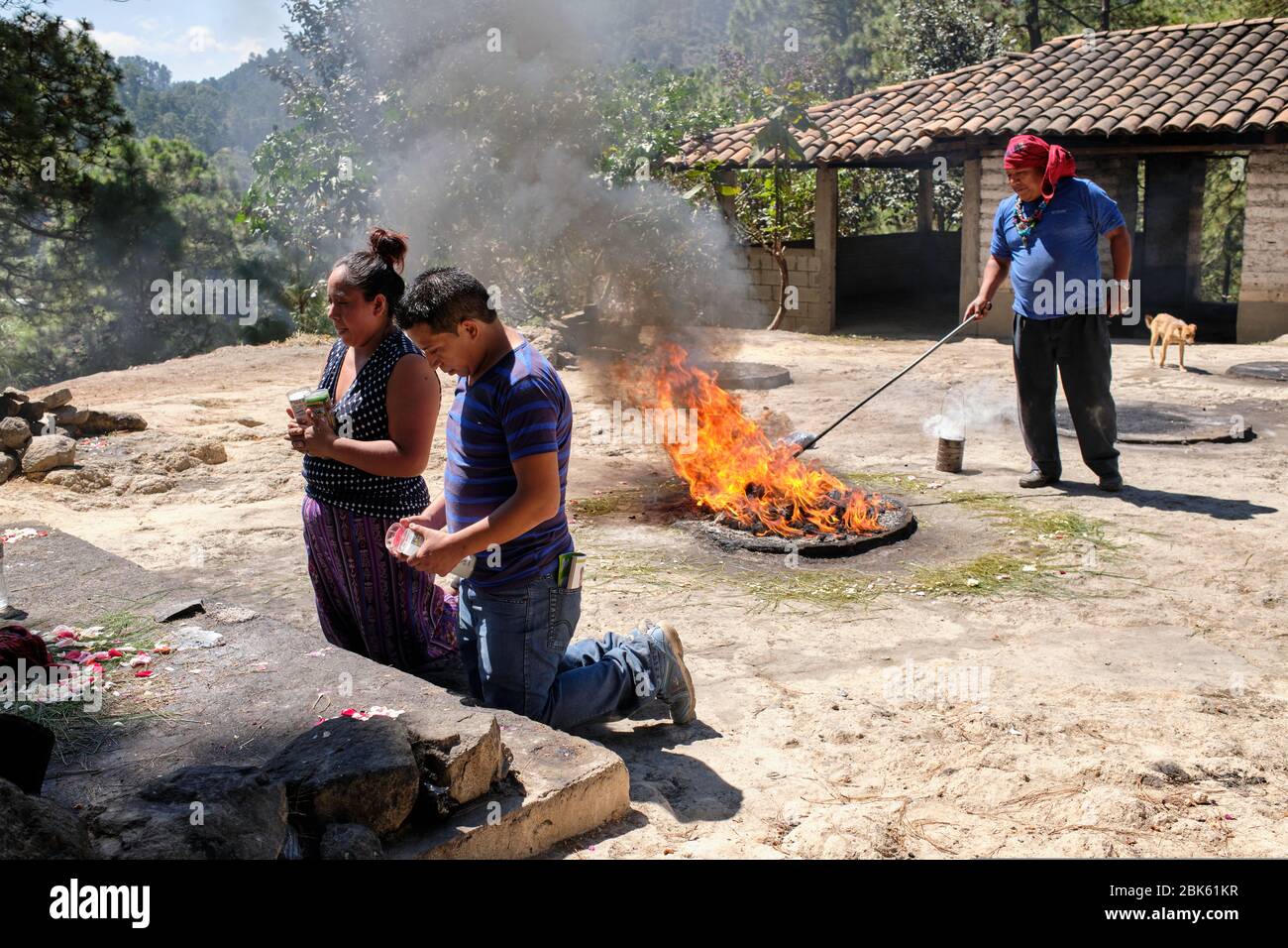 Shaman performing a Mayan healing ceremony for a family on the top of ...