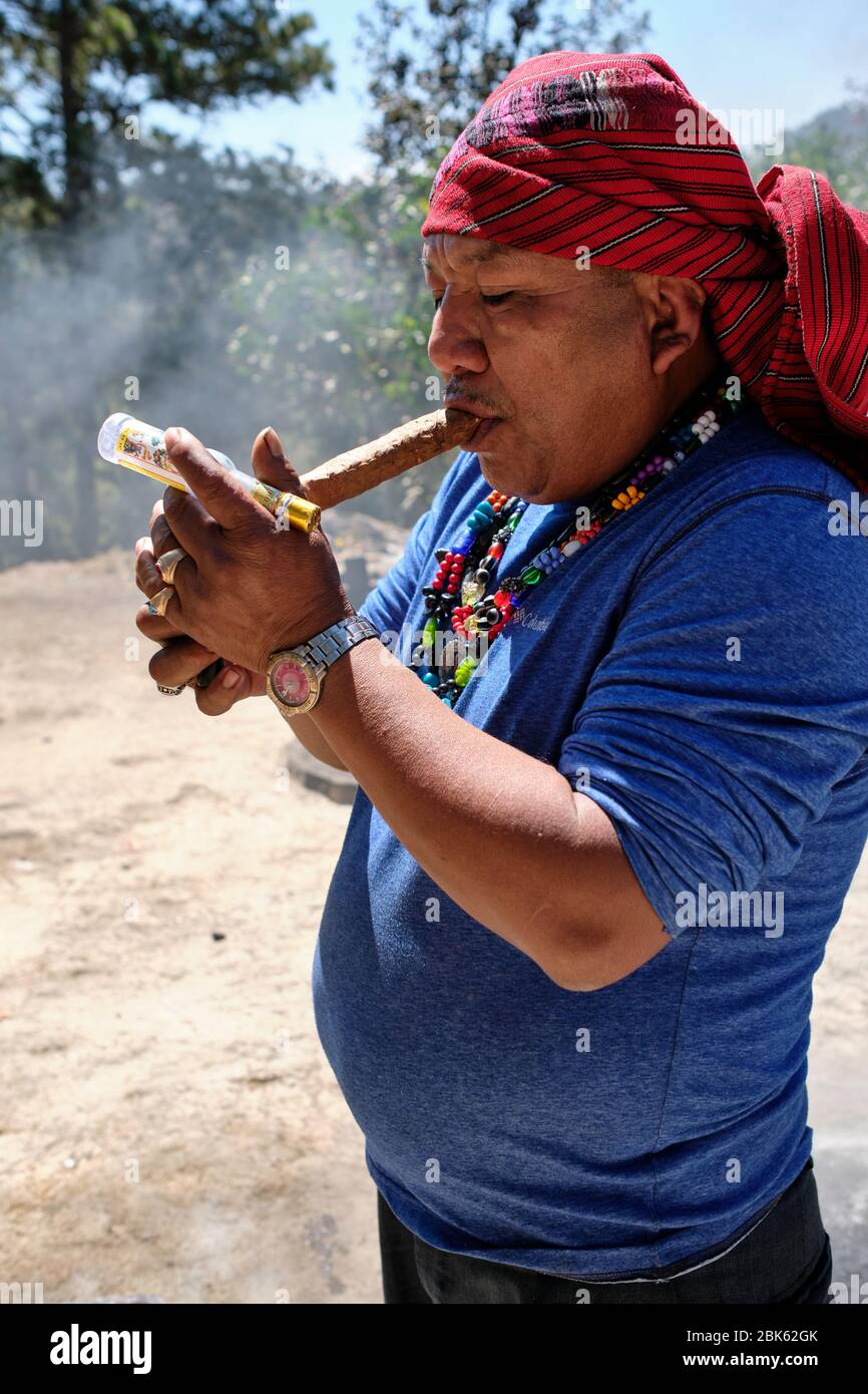 Shaman performing a Mayan healing ceremony for a family on the top of ...