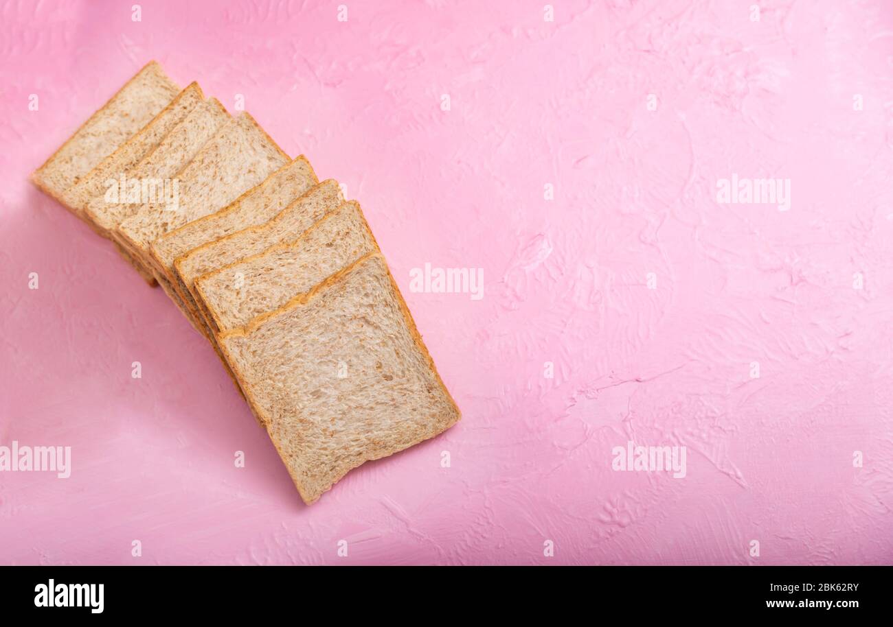 Bread slice isolated on color background. Bakery on the wooden pink ...