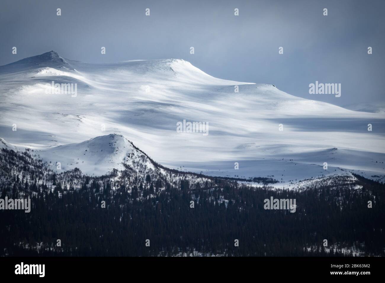 Winter landscape with dramatic snowy mountains Stock Photo - Alamy