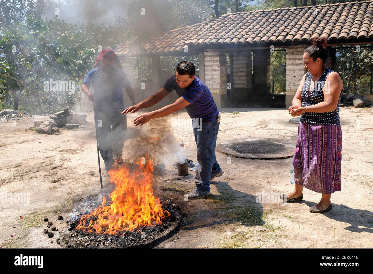 Shaman performing a Mayan healing ceremony for a family on the top of ...