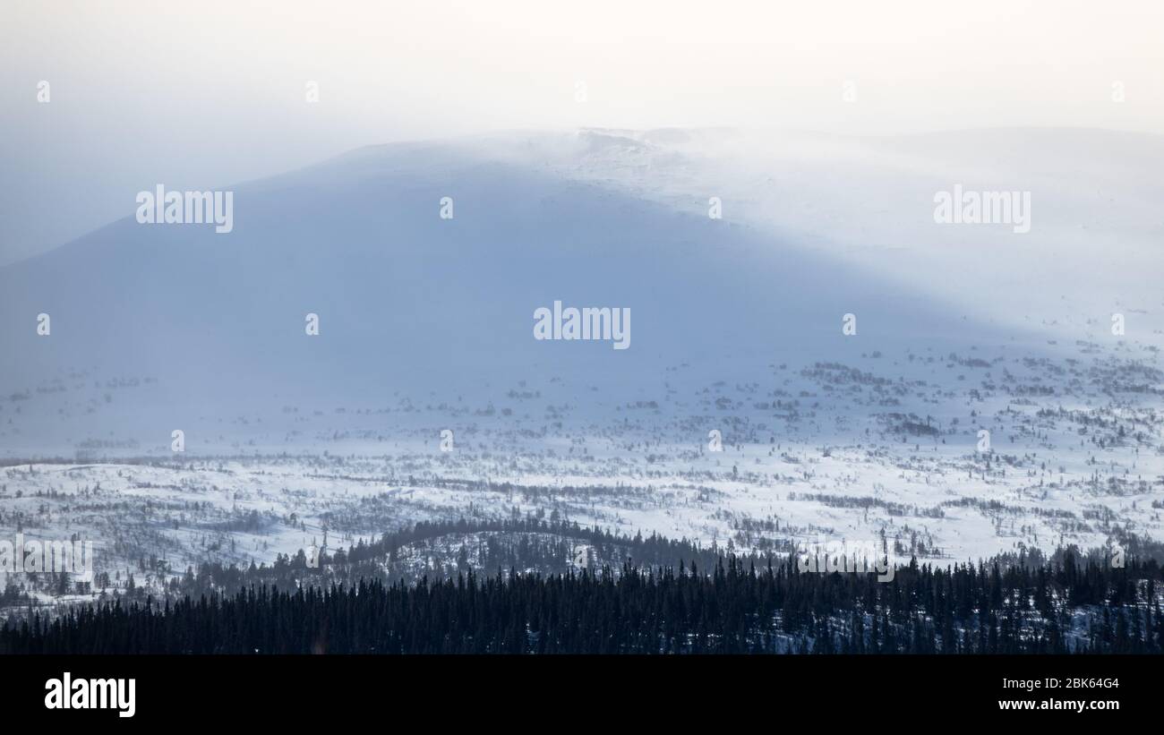 Winter landscape with foggy snowy mountains Stock Photo - Alamy