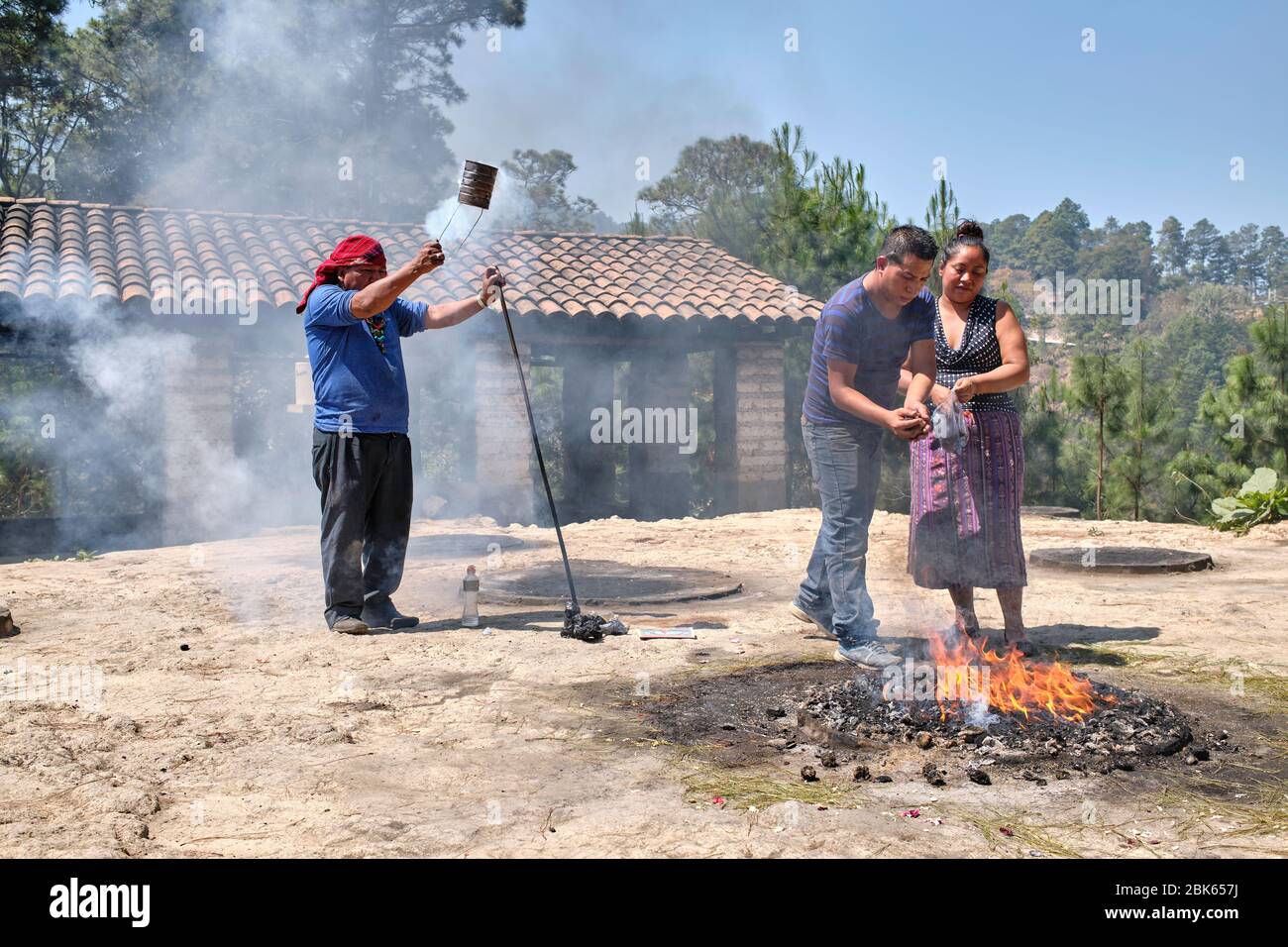 Shaman performing a Mayan healing ceremony for a family on the top of ...