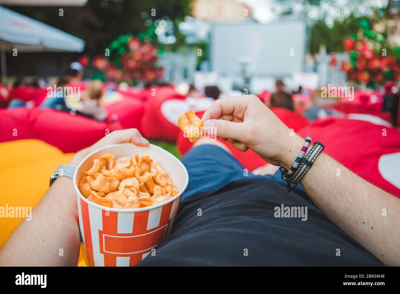 laying eating snacks watching movie at open air cinema Stock Photo - Alamy