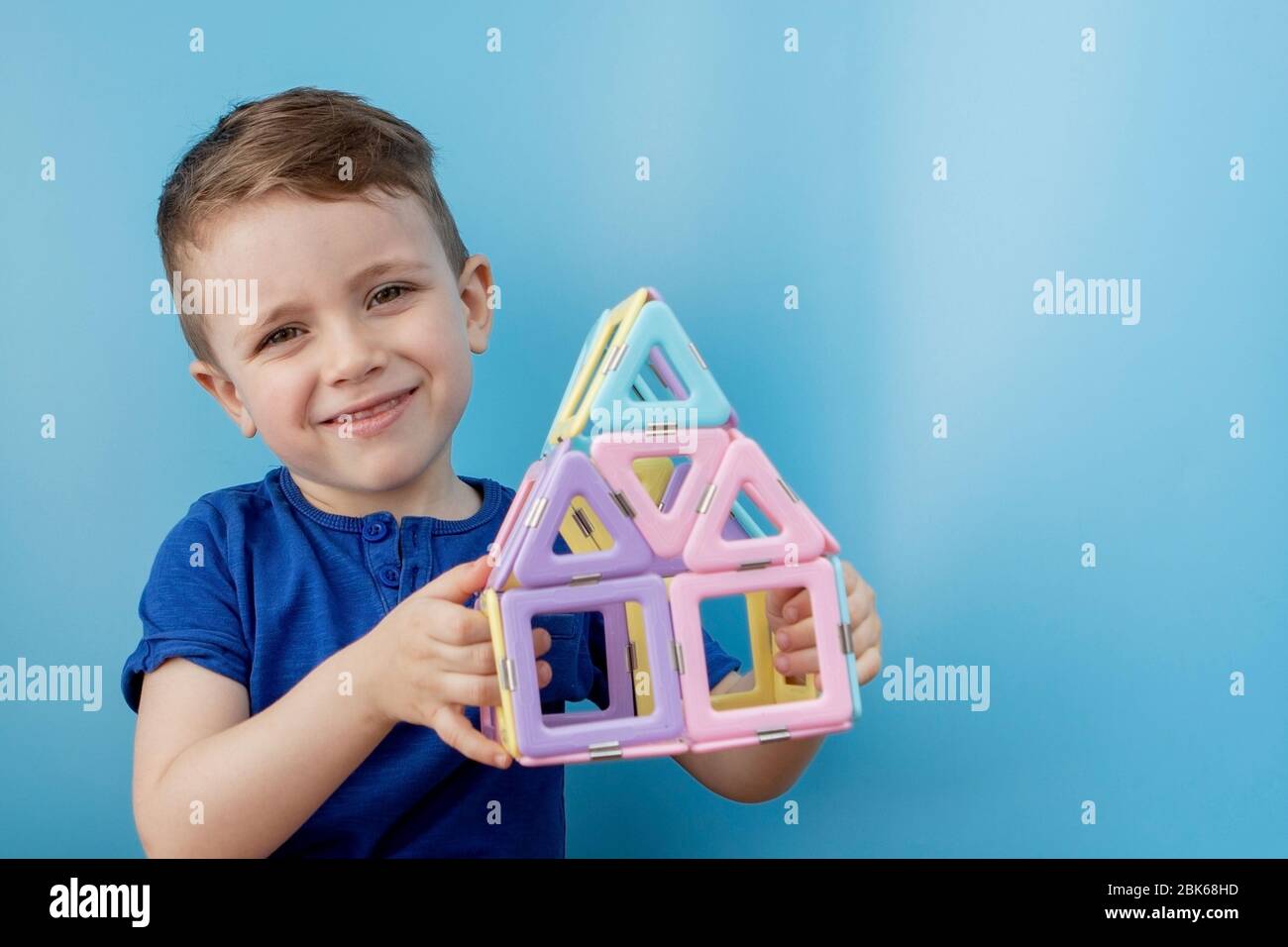 Boy looks through the shape in the color constructor with the ...