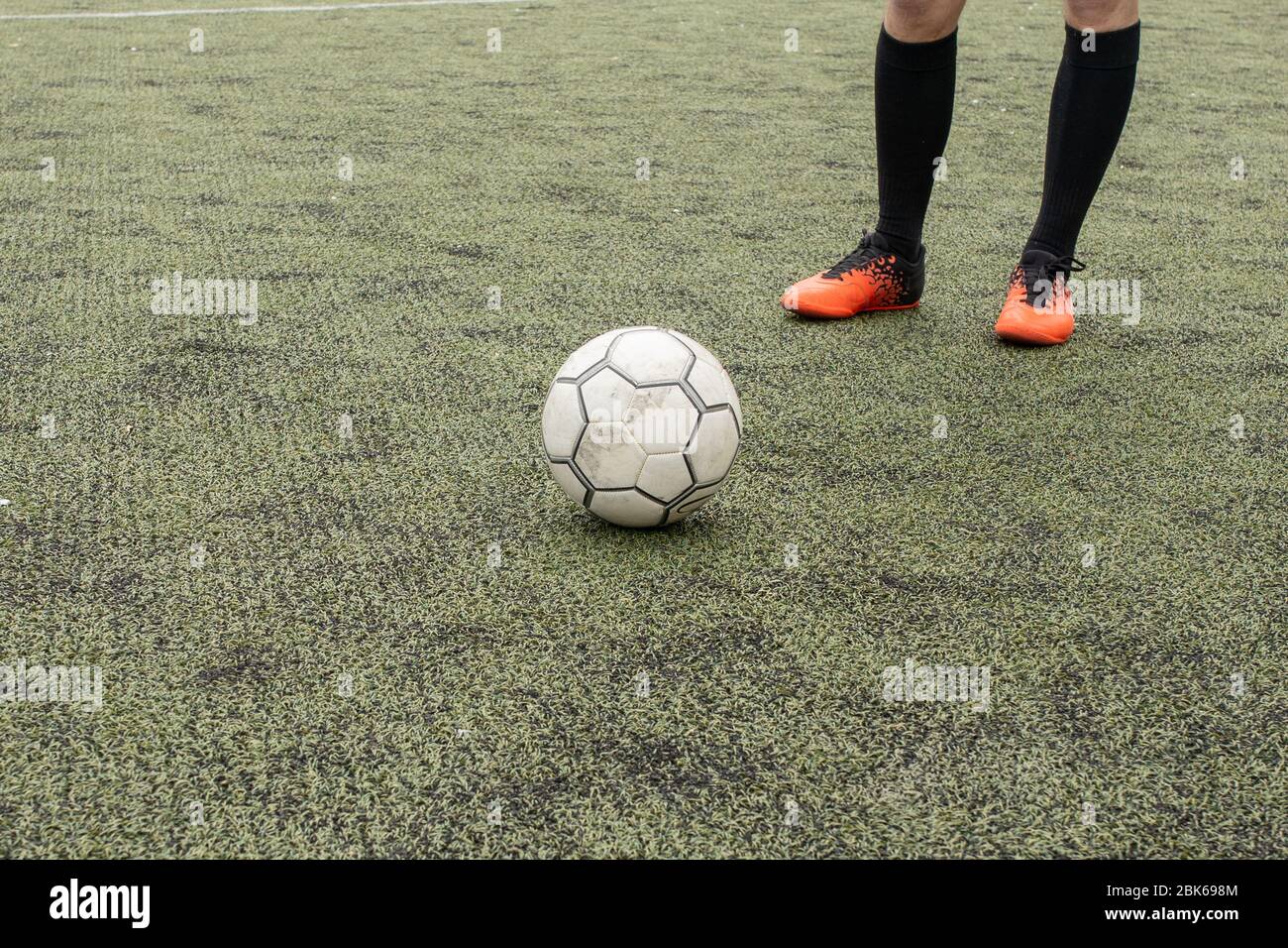 soccer ball with his feet on the football field Stock Photo - Alamy