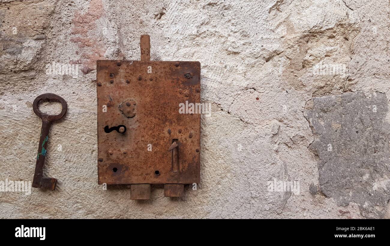 Antique rusty metal key and old rusty lock mechanism are displayed on ...