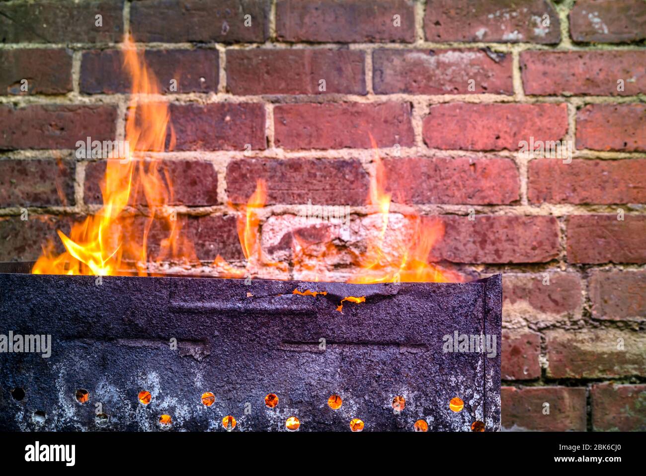 fire and grill over red brick wall background in backyard Stock Photo ...