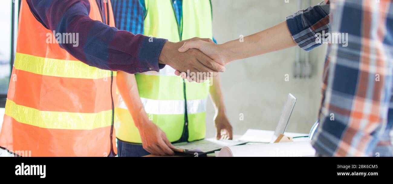 Handshake of two business man, after architect working and planning ...