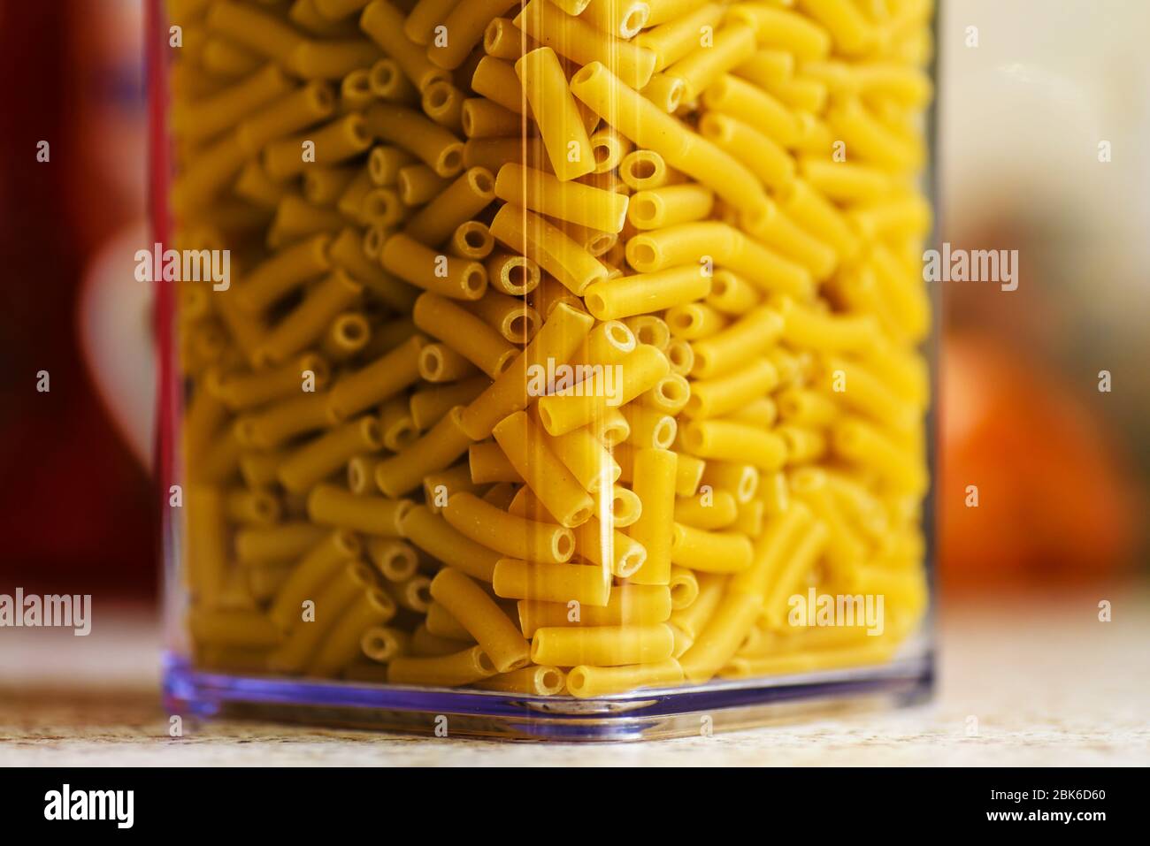raw italian macaroni pasta inside clear storage container Stock Photo ...