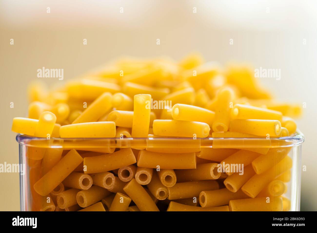 raw italian macaroni pasta inside clear storage container Stock Photo ...