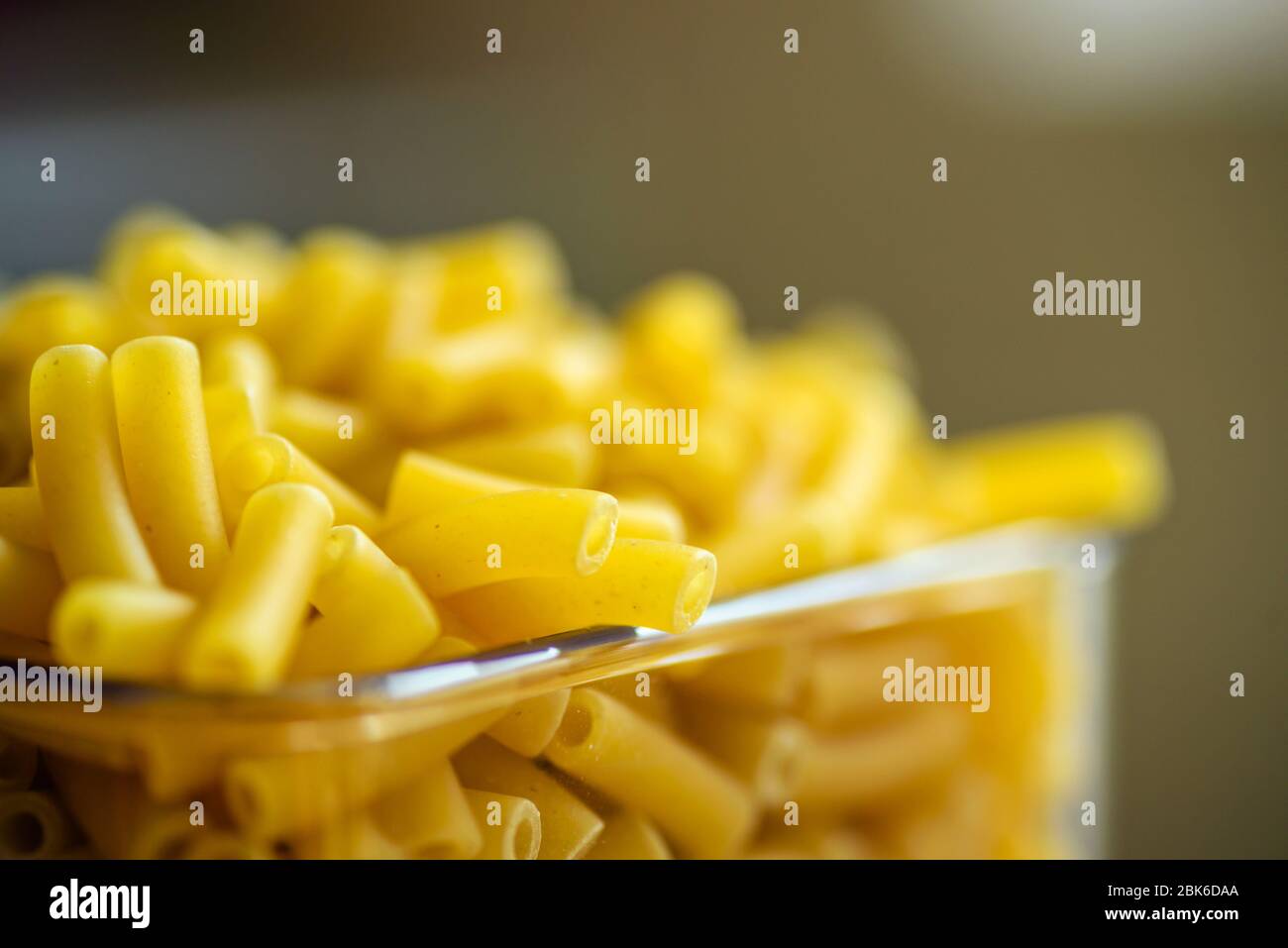 raw italian macaroni pasta inside clear storage container Stock Photo ...