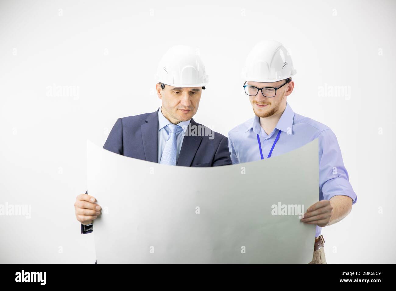 Engineer and architect in hard safety helmet hats designing, planing ...