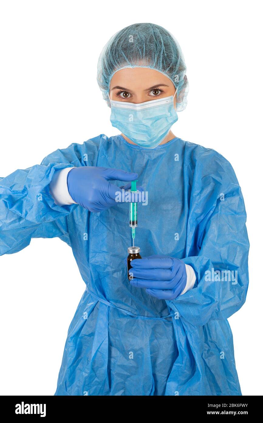 Female surgeon wearing protective uniform is holding a syringe with ... Female surgeon wearing protective uniform is holding a syringe with ...